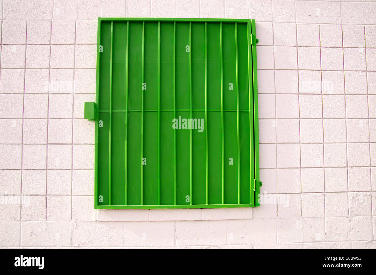 Green mesh shutter on white wall Stock Photo - Alamy