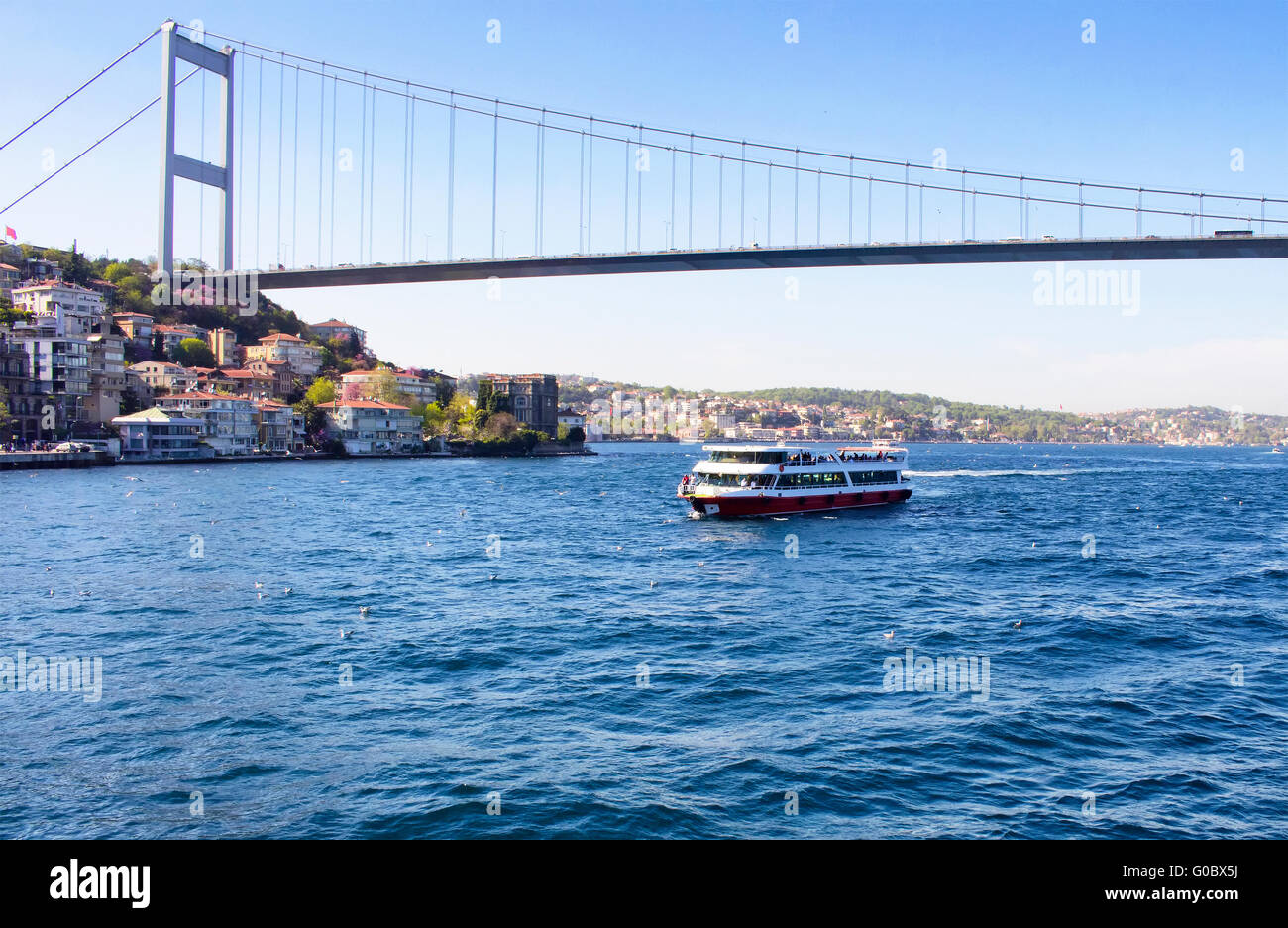 Tour boat passes FSM bridge in Istanbul Stock Photo - Alamy