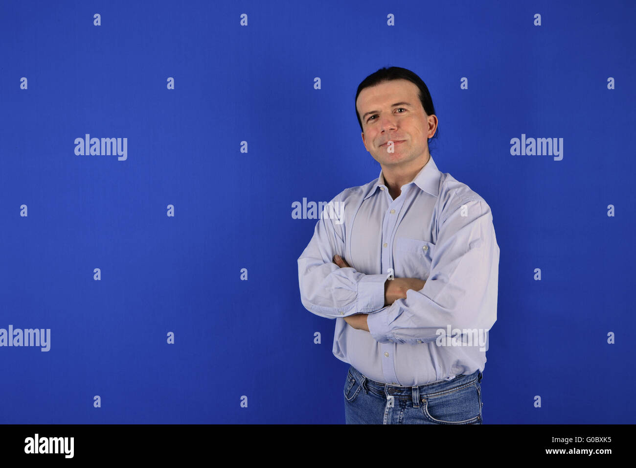 Man against blue background Stock Photo - Alamy