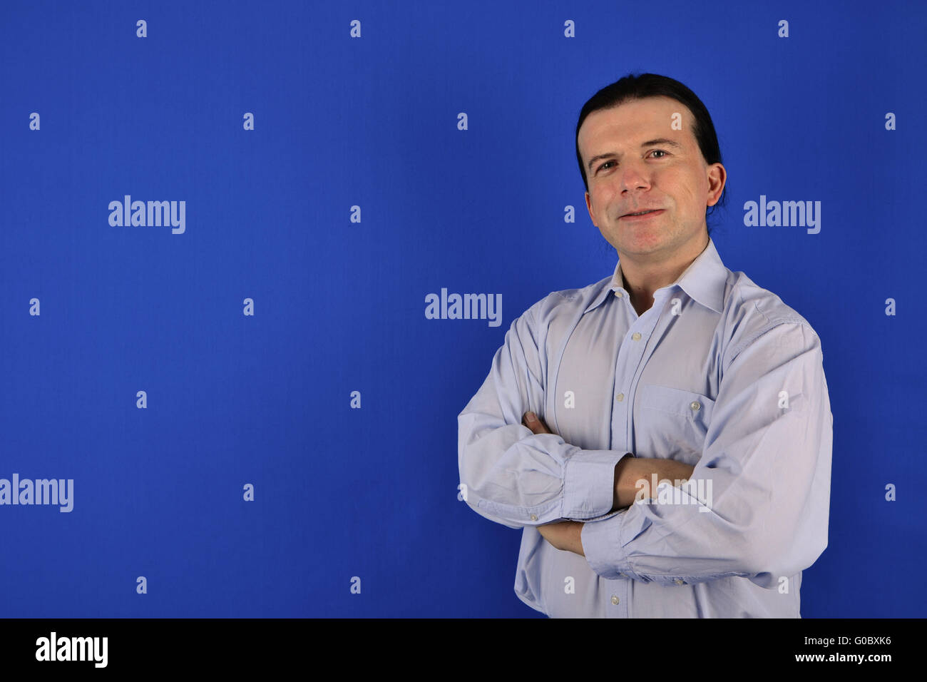 Man against blue background Stock Photo - Alamy