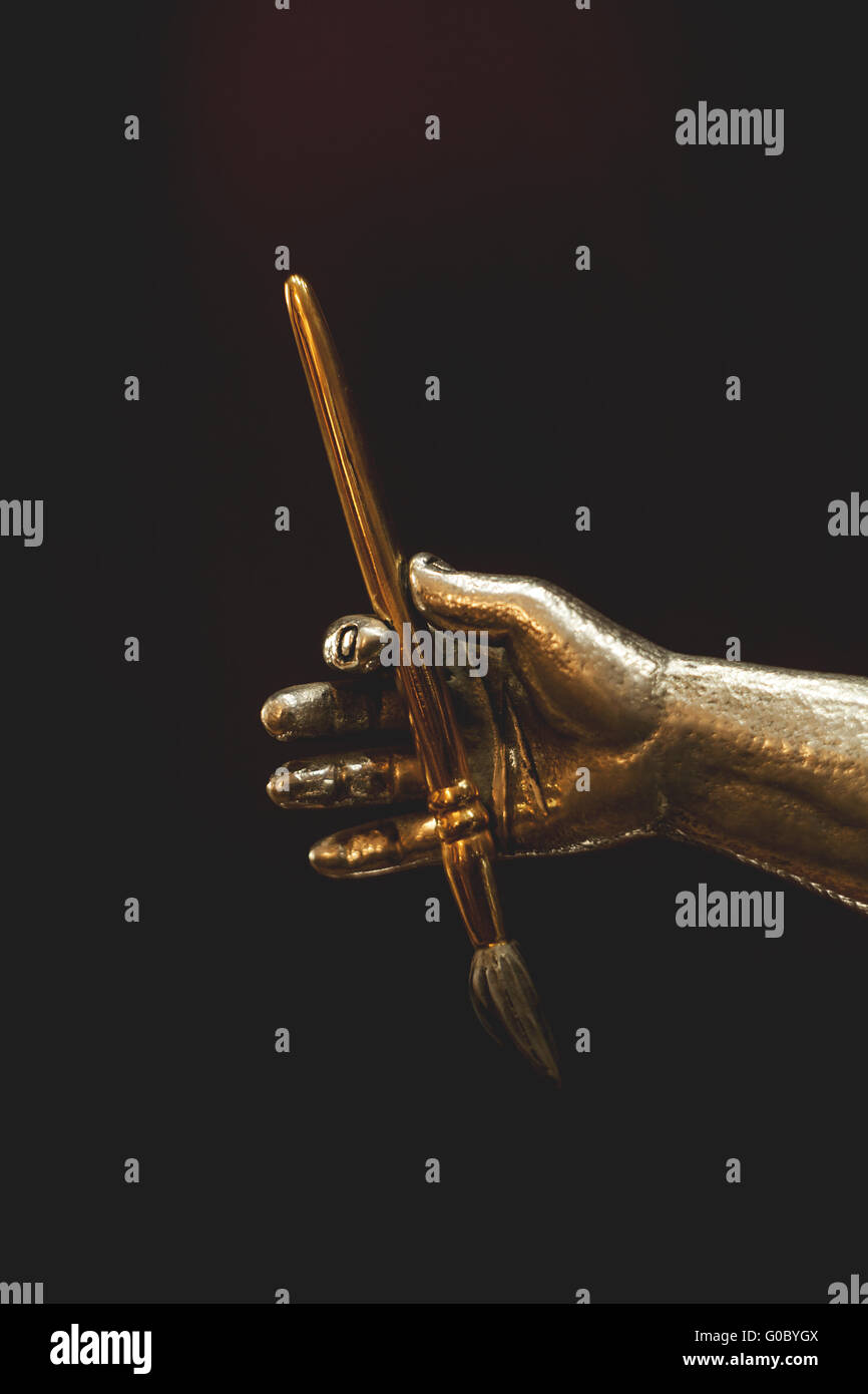 bronze hand with brush Stock Photo - Alamy