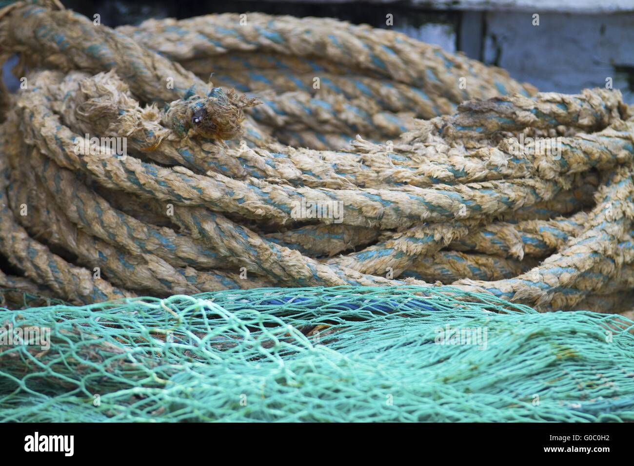 Coiled ropes and fishing nets on fishing boat Stock Photo - Alamy