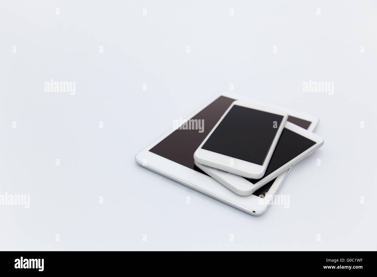 stacked cell phone and tablet Stock Photo - Alamy