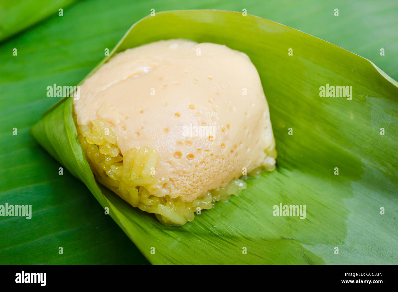 Thai Traditional Dessert, Sticky rice custard wrapped in banana leaves ...