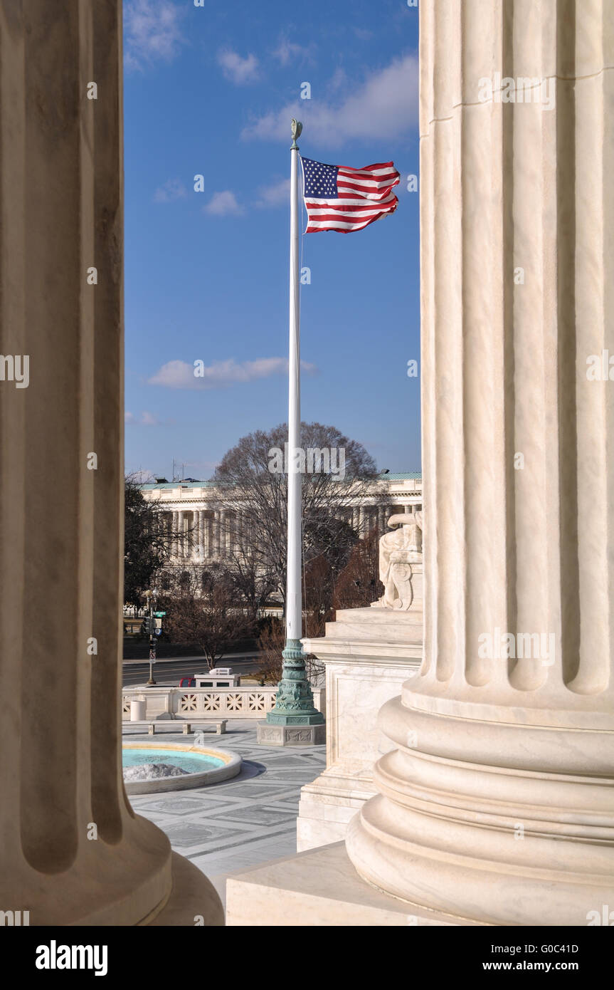 Flag flying between two pillars of the Supreme Court of the United ...