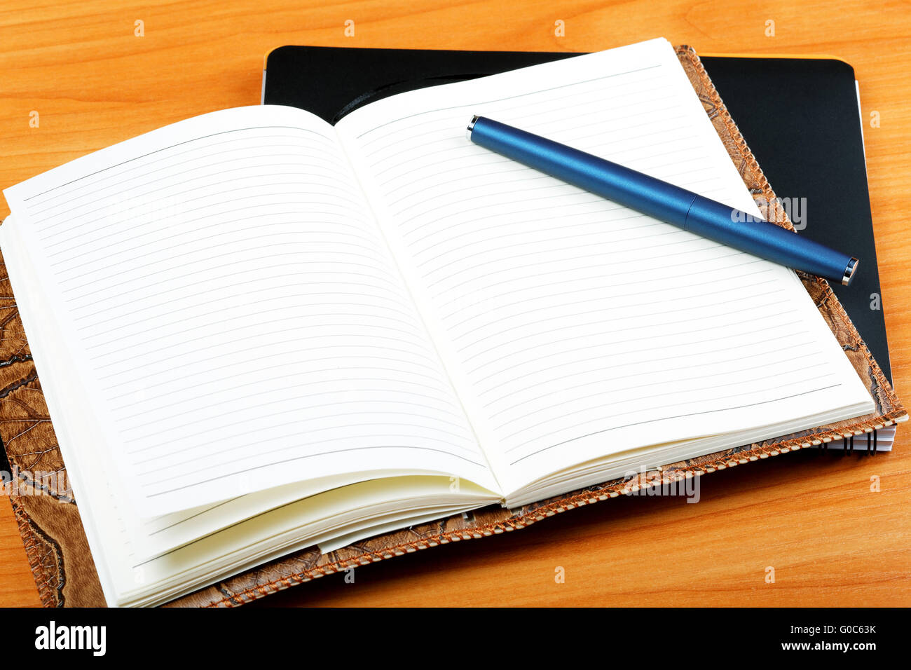 The opened writing-book in a leather cover and pen Stock Photo - Alamy