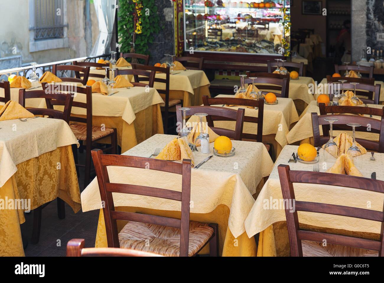Street view of a Cafe terrace with tables and chairs Sicily Stock Photo ...