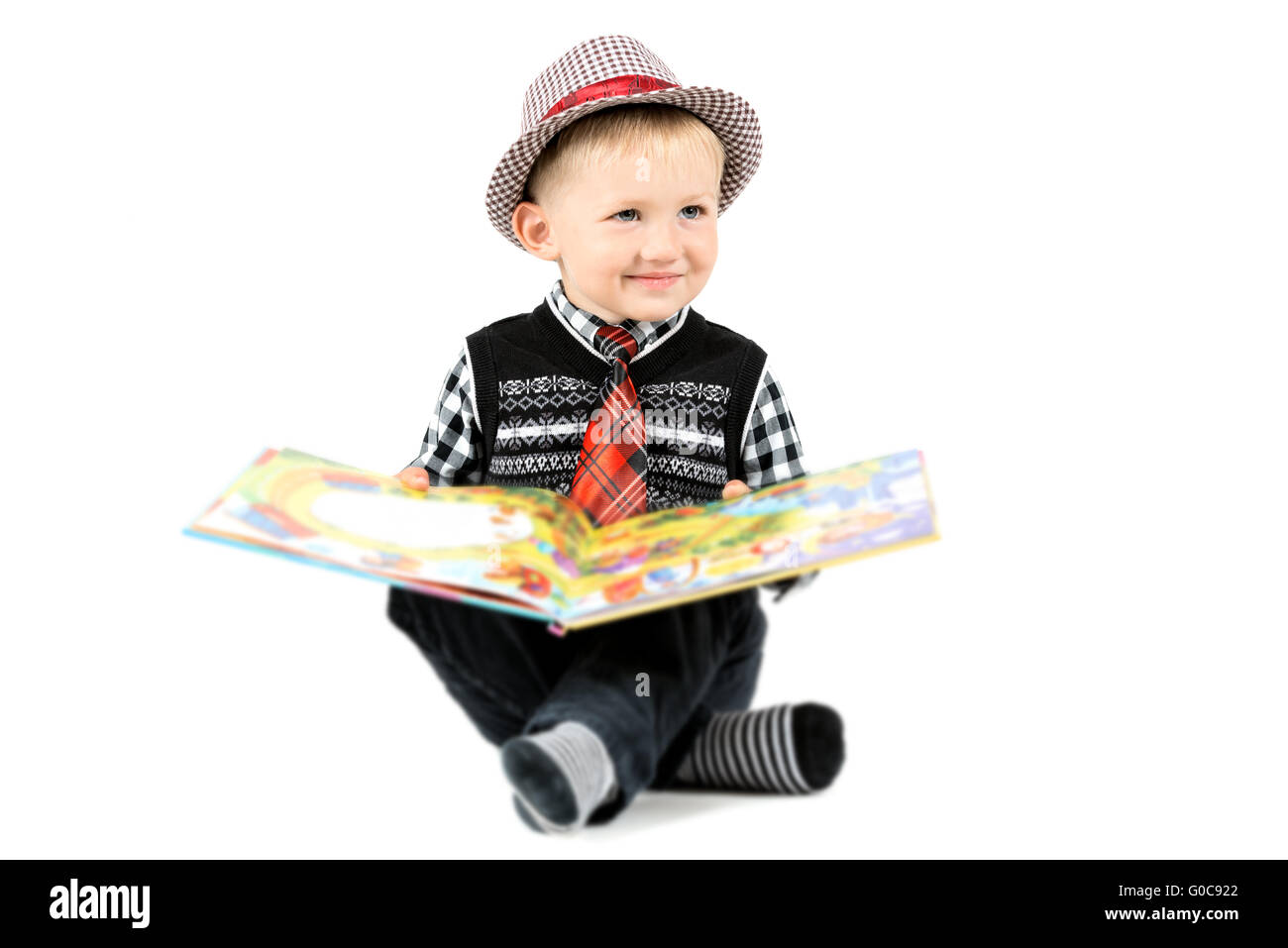 Smiling happy boy with book studio shot isolated on a white background ...