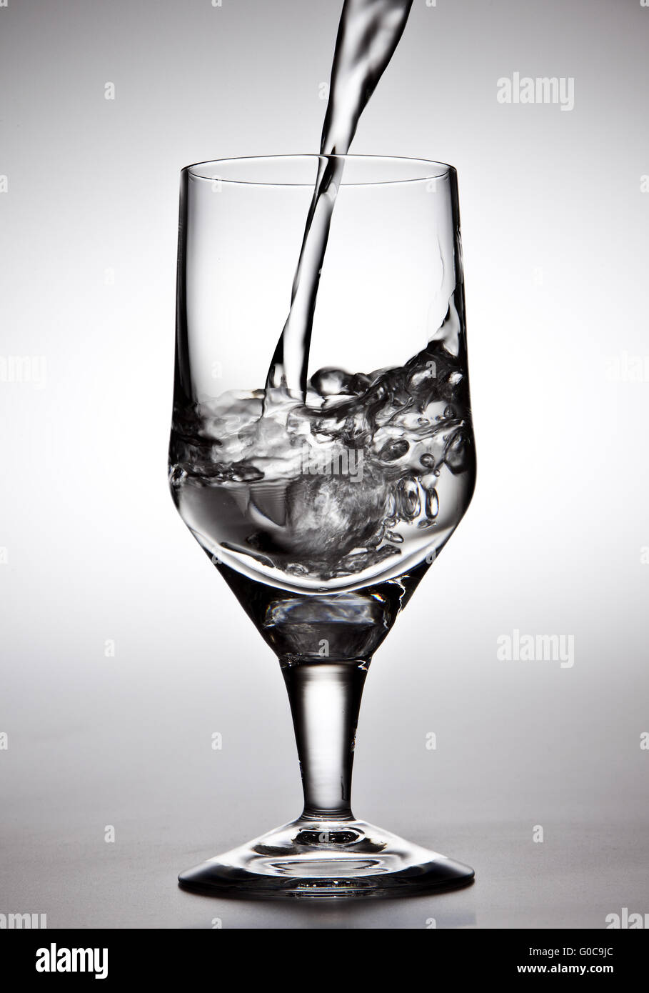 Water is being poured into a glass Stock Photo - Alamy