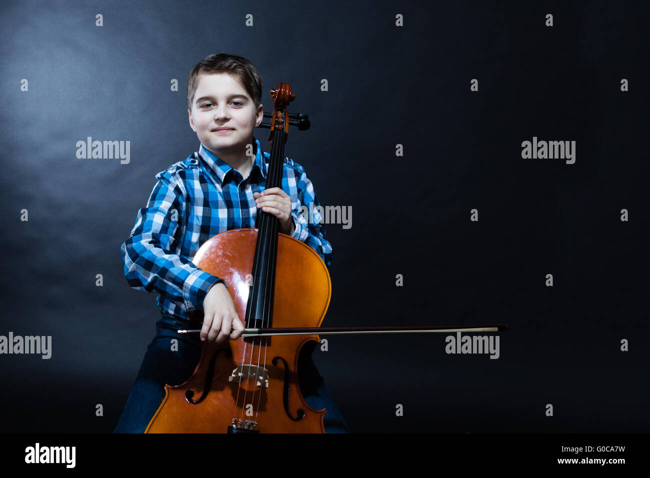 Boy playing cello hi-res stock photography and images - Alamy