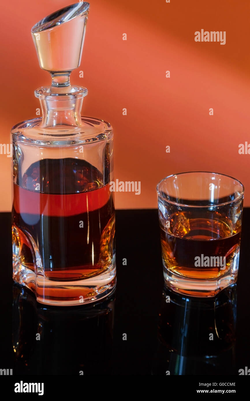 bottle and glass of whiskey on gradient background Stock Photo - Alamy