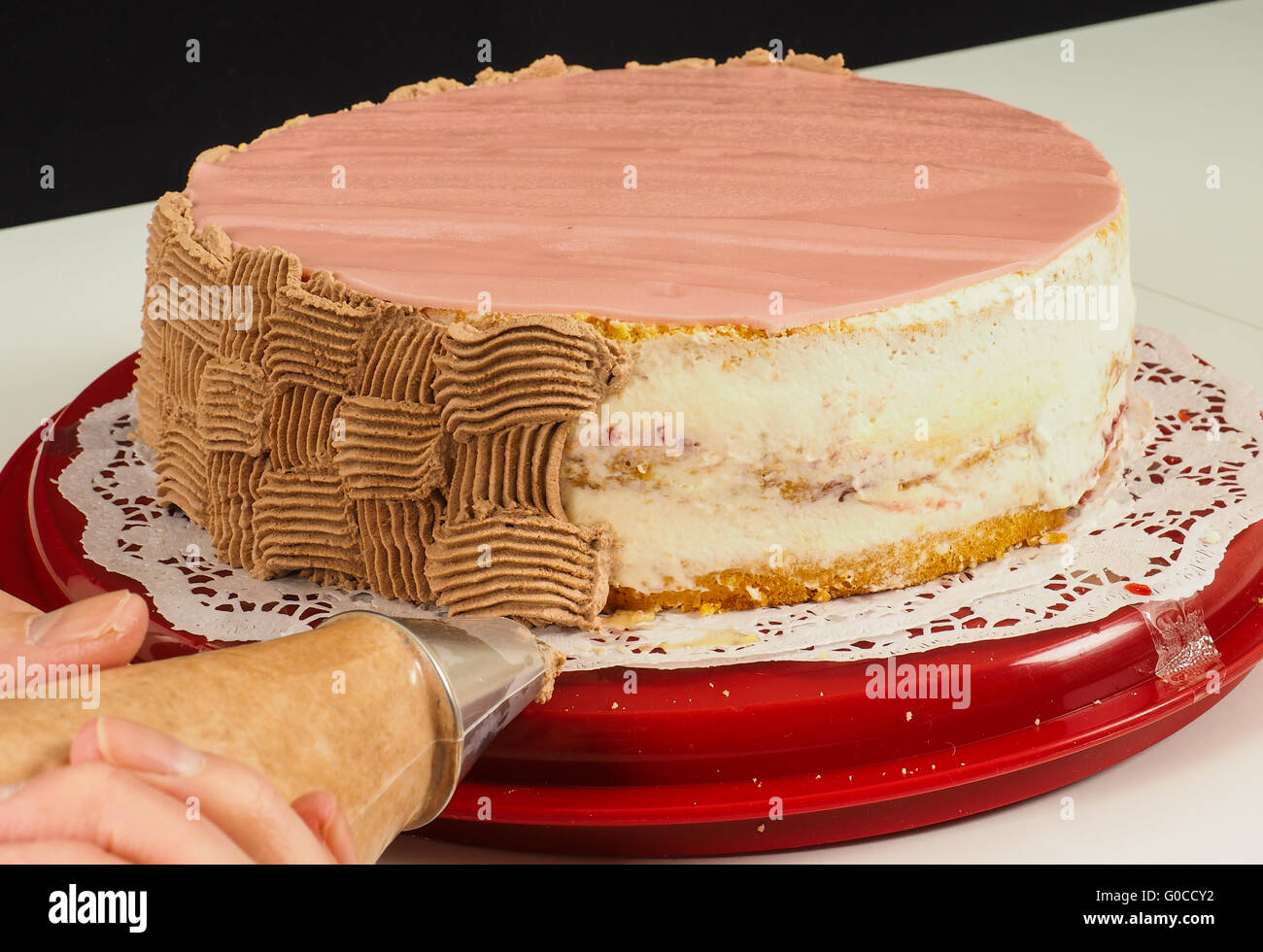 Professional cake baker, chocolate cream Stock Photo - Alamy