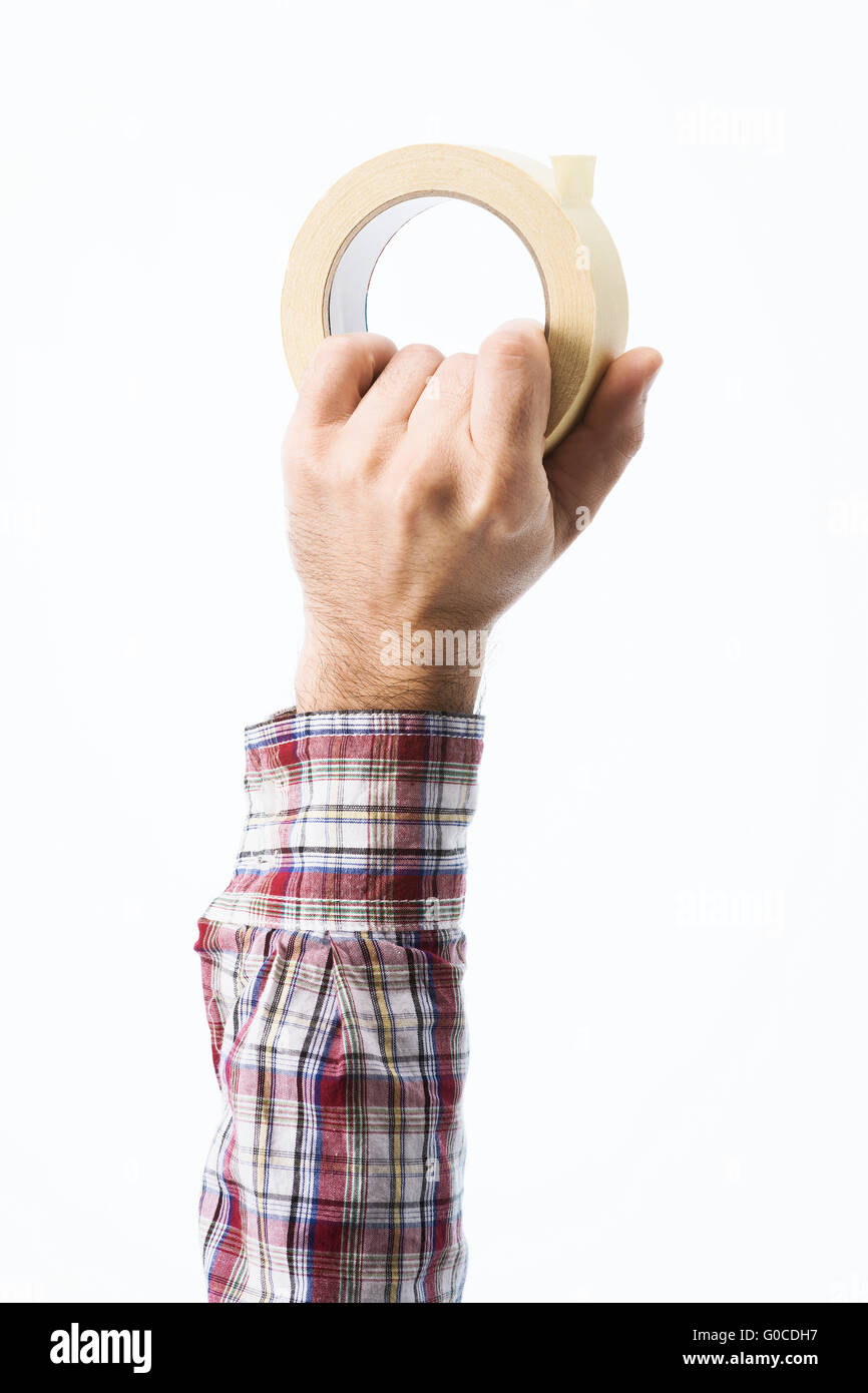 Male hand holding a roll of masking tape on white background Stock ...