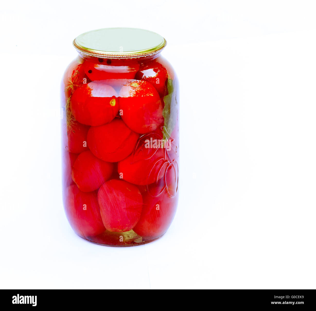 Canned tomatoes in a large glass jar on white back Stock Photo - Alamy