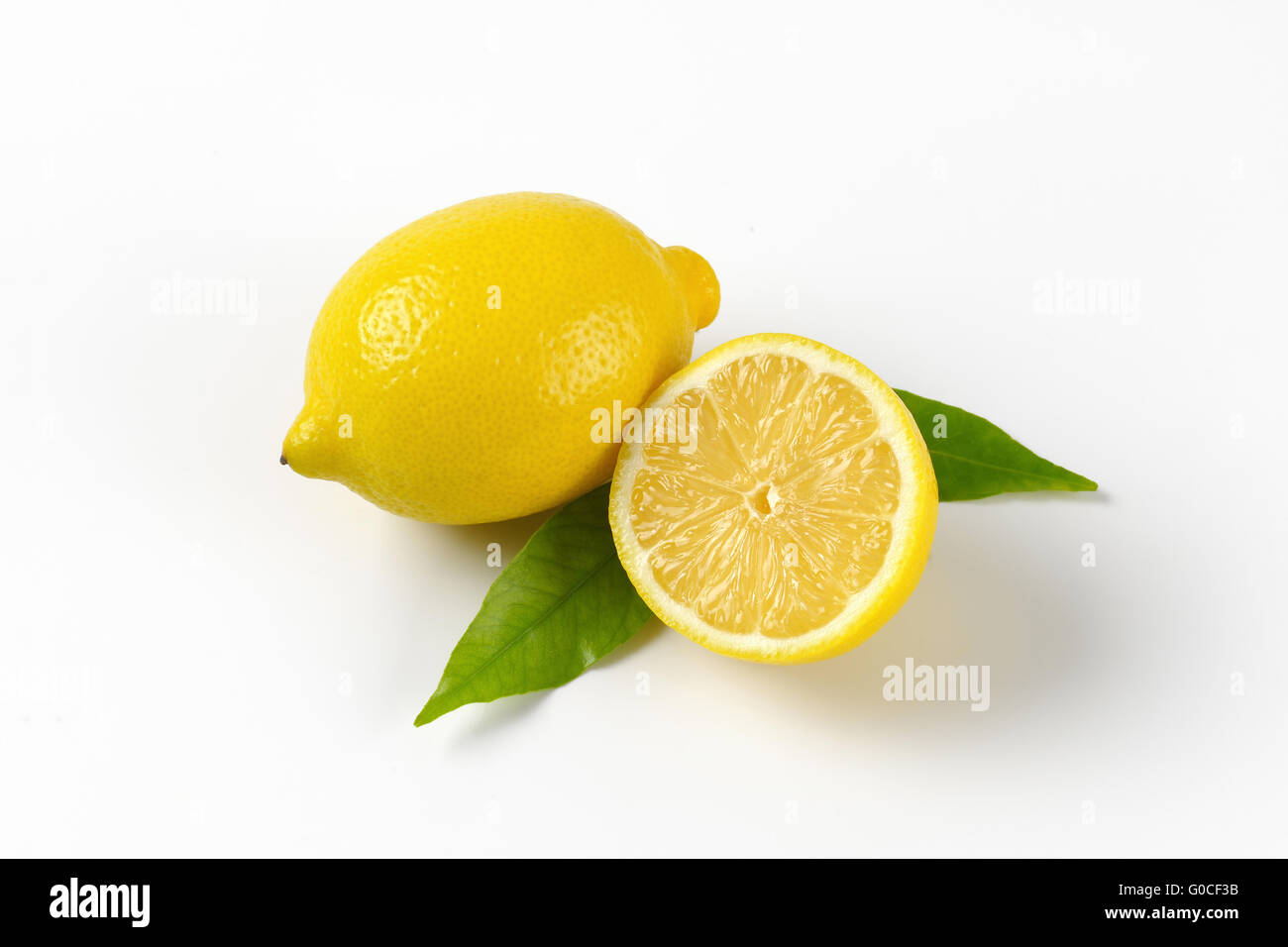 one and half lemon with leaves on white background Stock Photo - Alamy