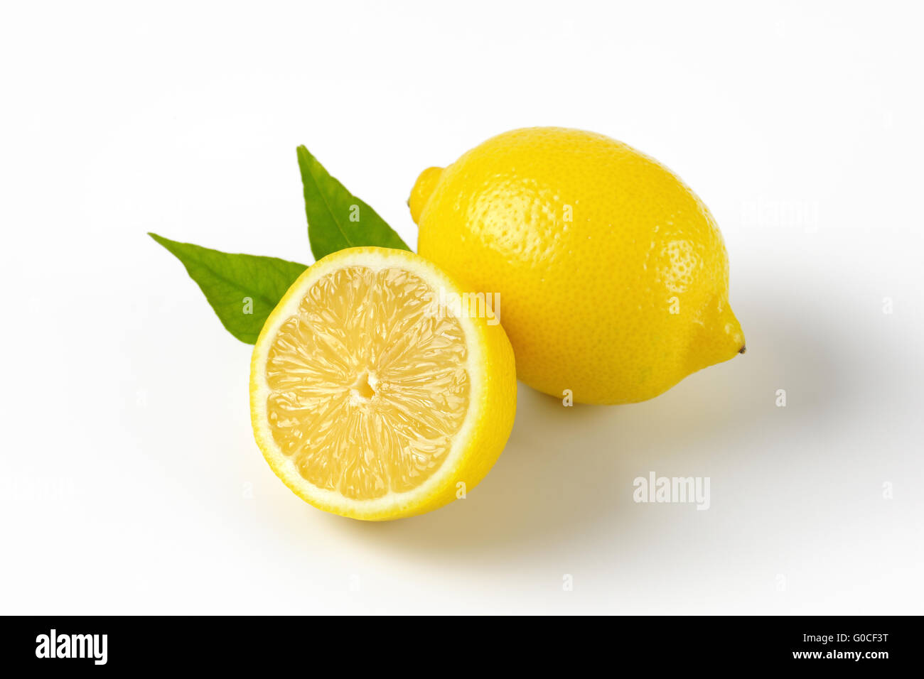 one and half lemon with leaves on white background Stock Photo - Alamy