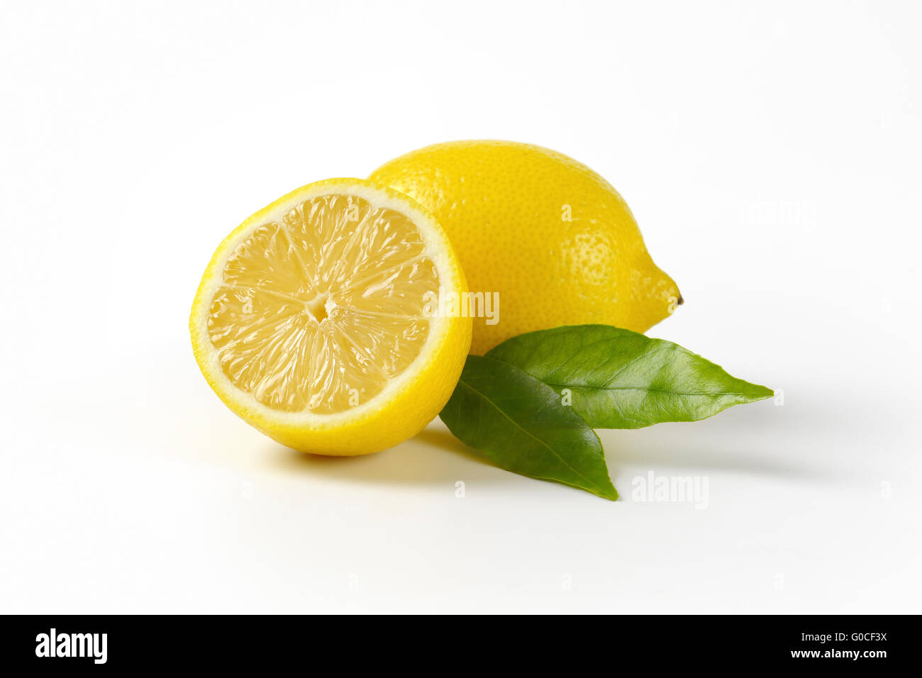 one and half lemon with leaves on white background Stock Photo - Alamy