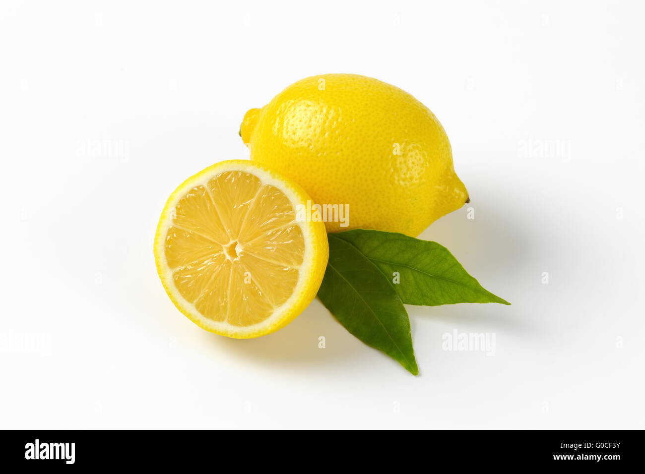 one and half lemon with leaves on white background Stock Photo - Alamy