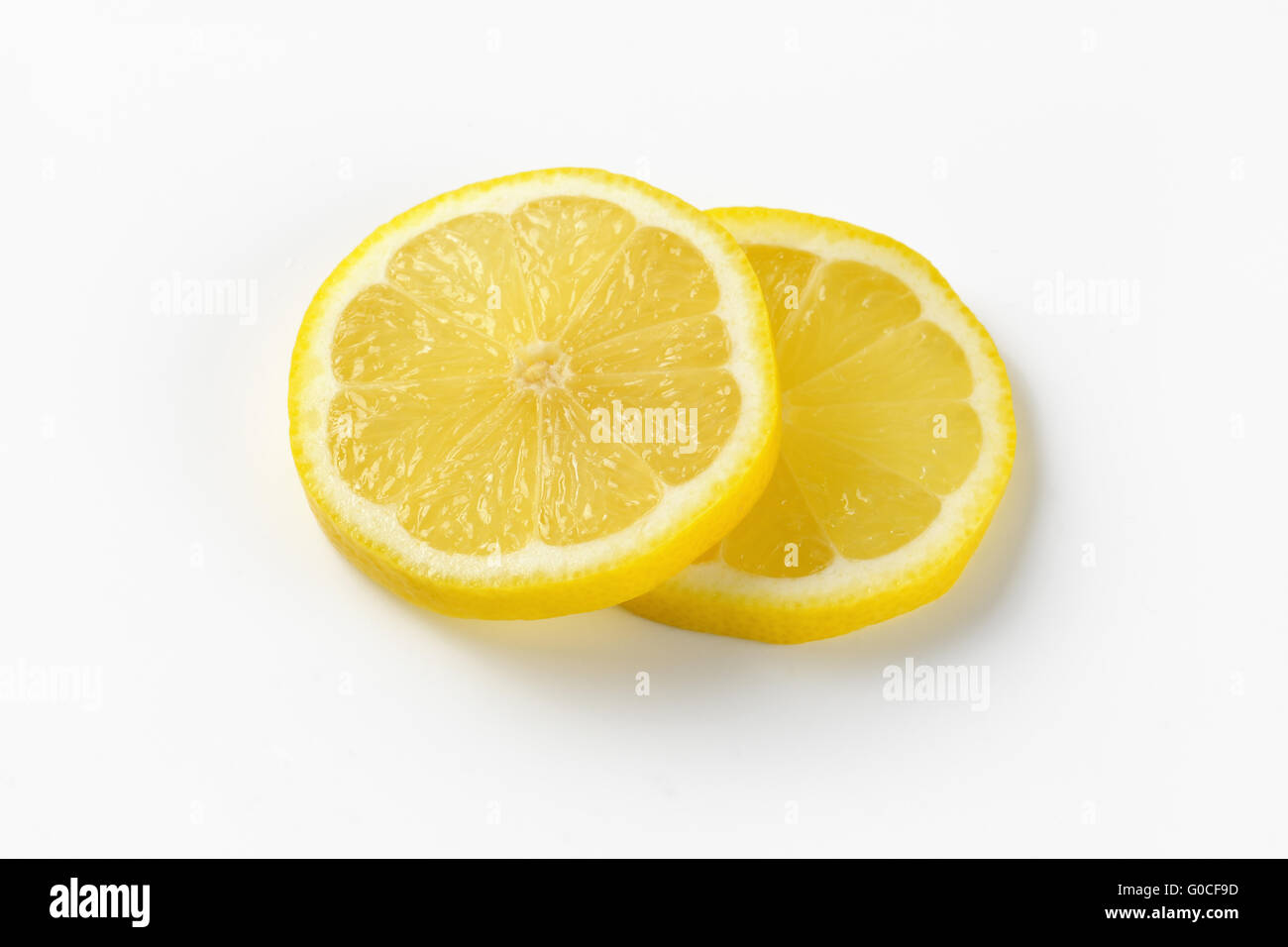 two thin slices of fresh lemon on white background Stock Photo - Alamy