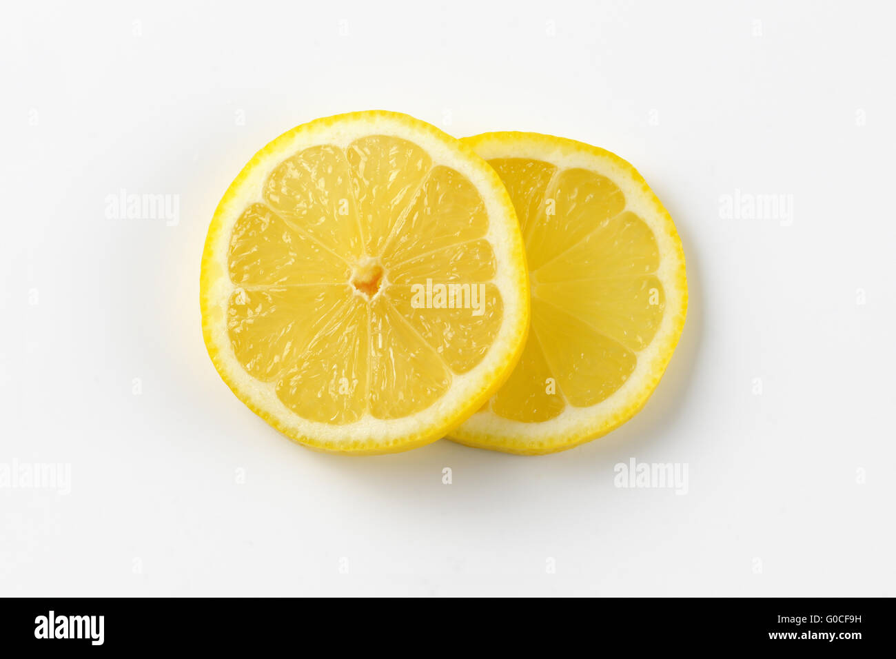 two thin slices of fresh lemon on white background Stock Photo - Alamy