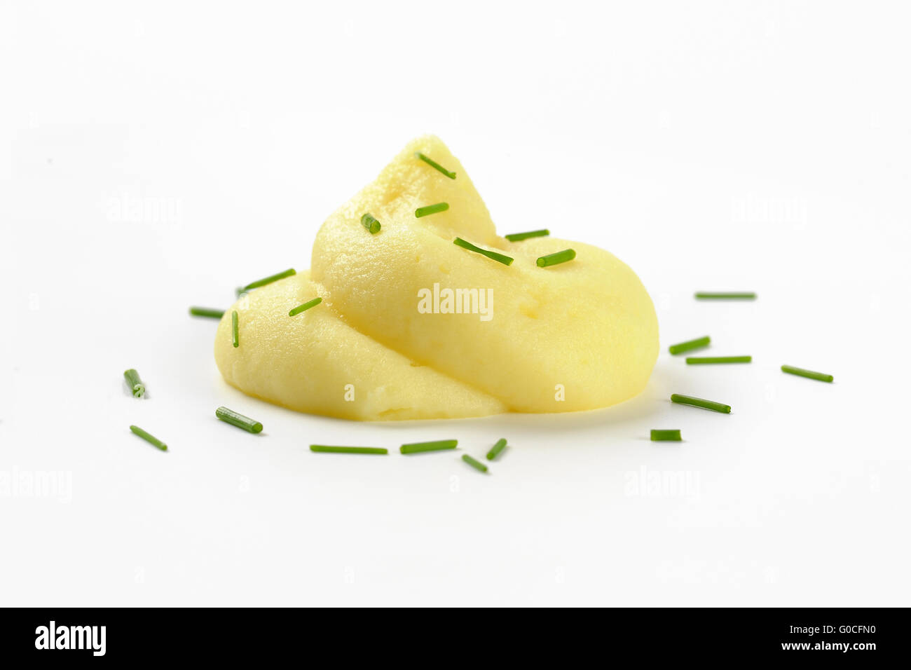 swirl of mashed potatoes with chives on white background Stock Photo ...