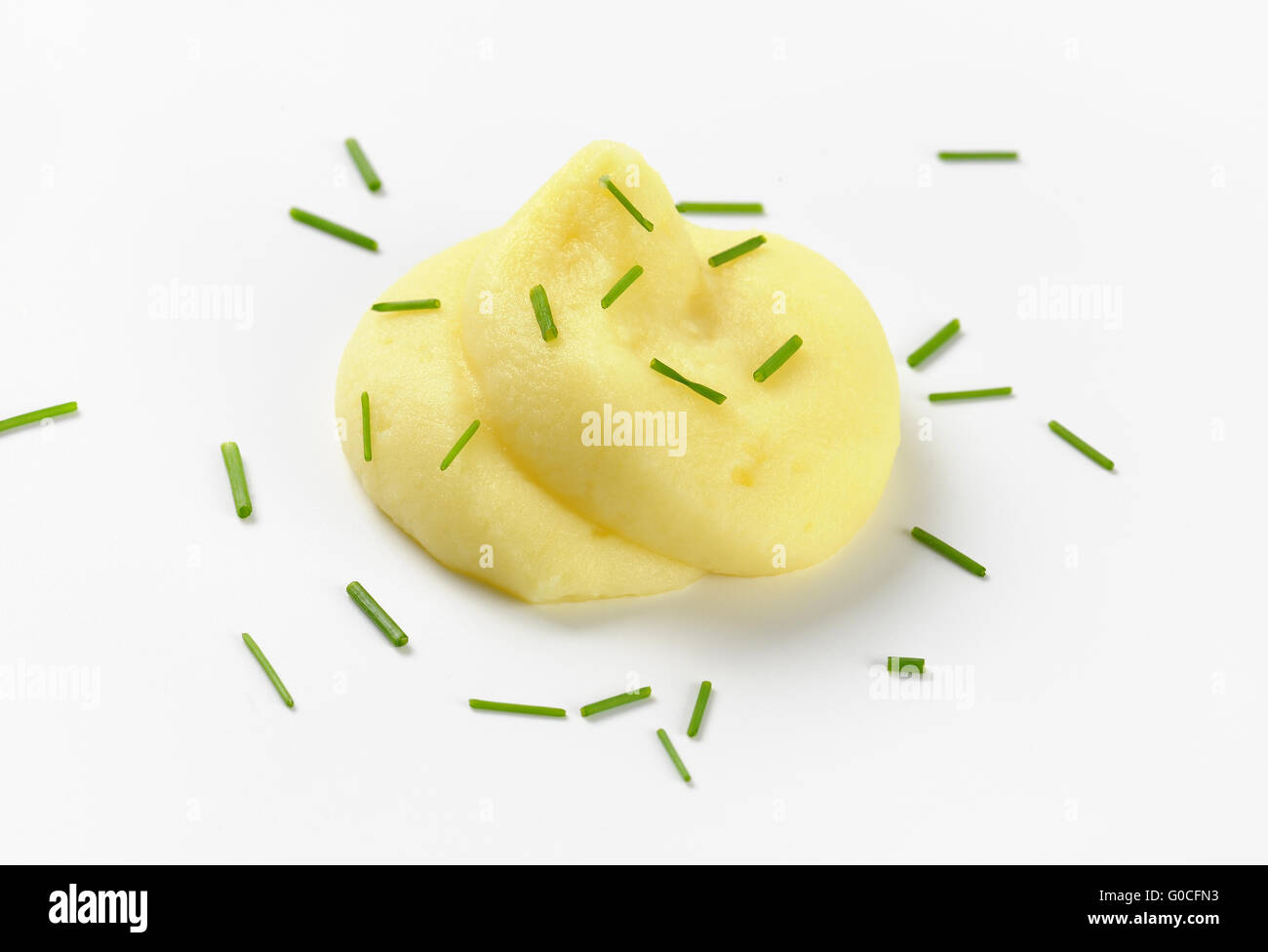 swirl of mashed potatoes with chives on white background Stock Photo ...