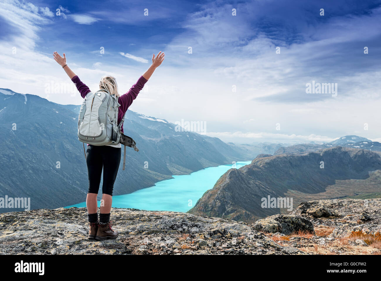 woman is feeling free and standing with hands up Stock Photo - Alamy