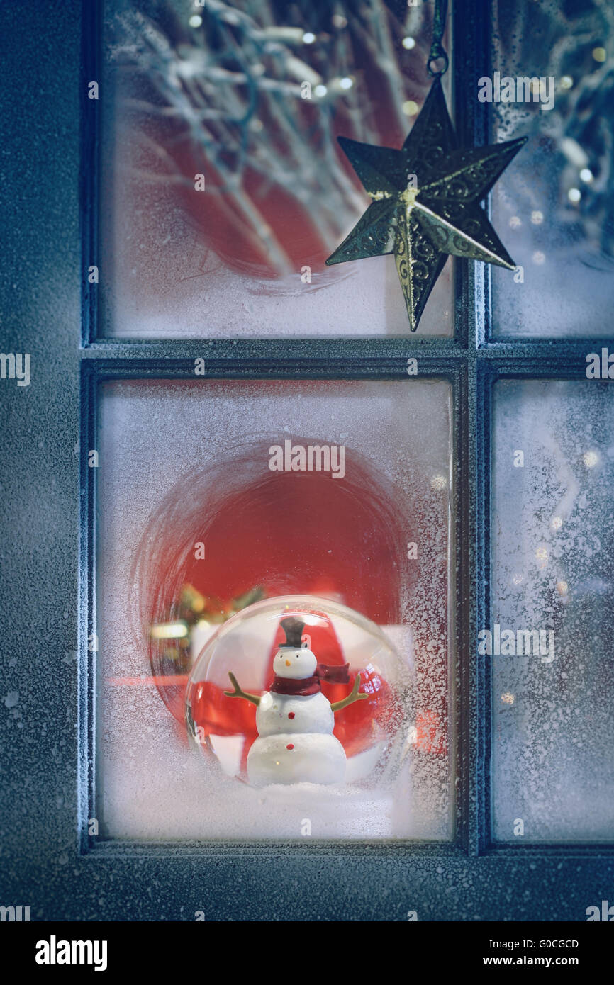 Frosted window with Christmas decoration inside at Stock Photo - Alamy