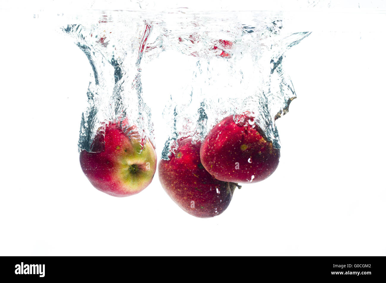 Apples fall deeply under water Stock Photo - Alamy