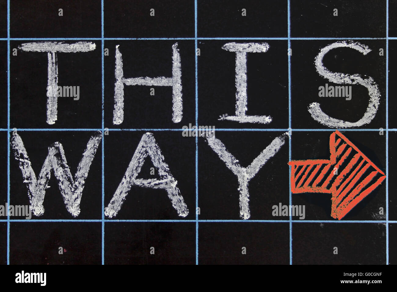 this way phrase handwritten on black chalkboard Stock Photo - Alamy