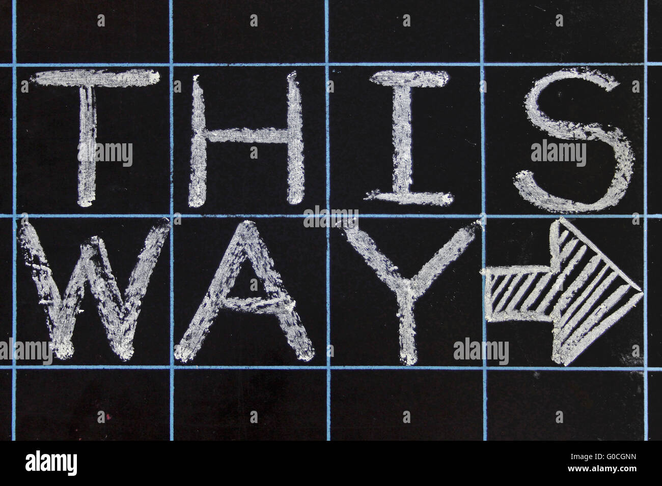 this way phrase handwritten on black chalkboard Stock Photo - Alamy