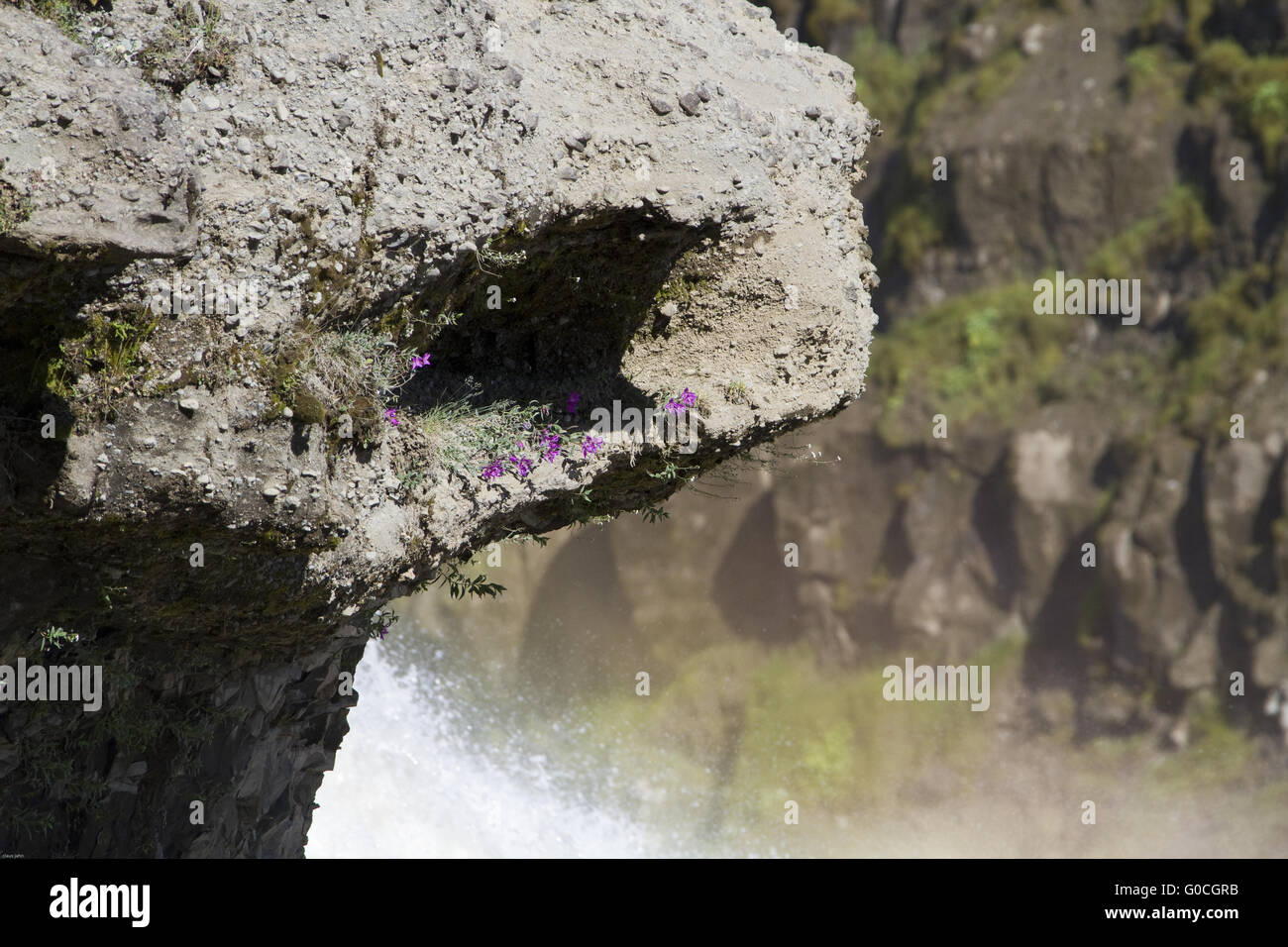 Boulder on waterfall Stock Photo - Alamy