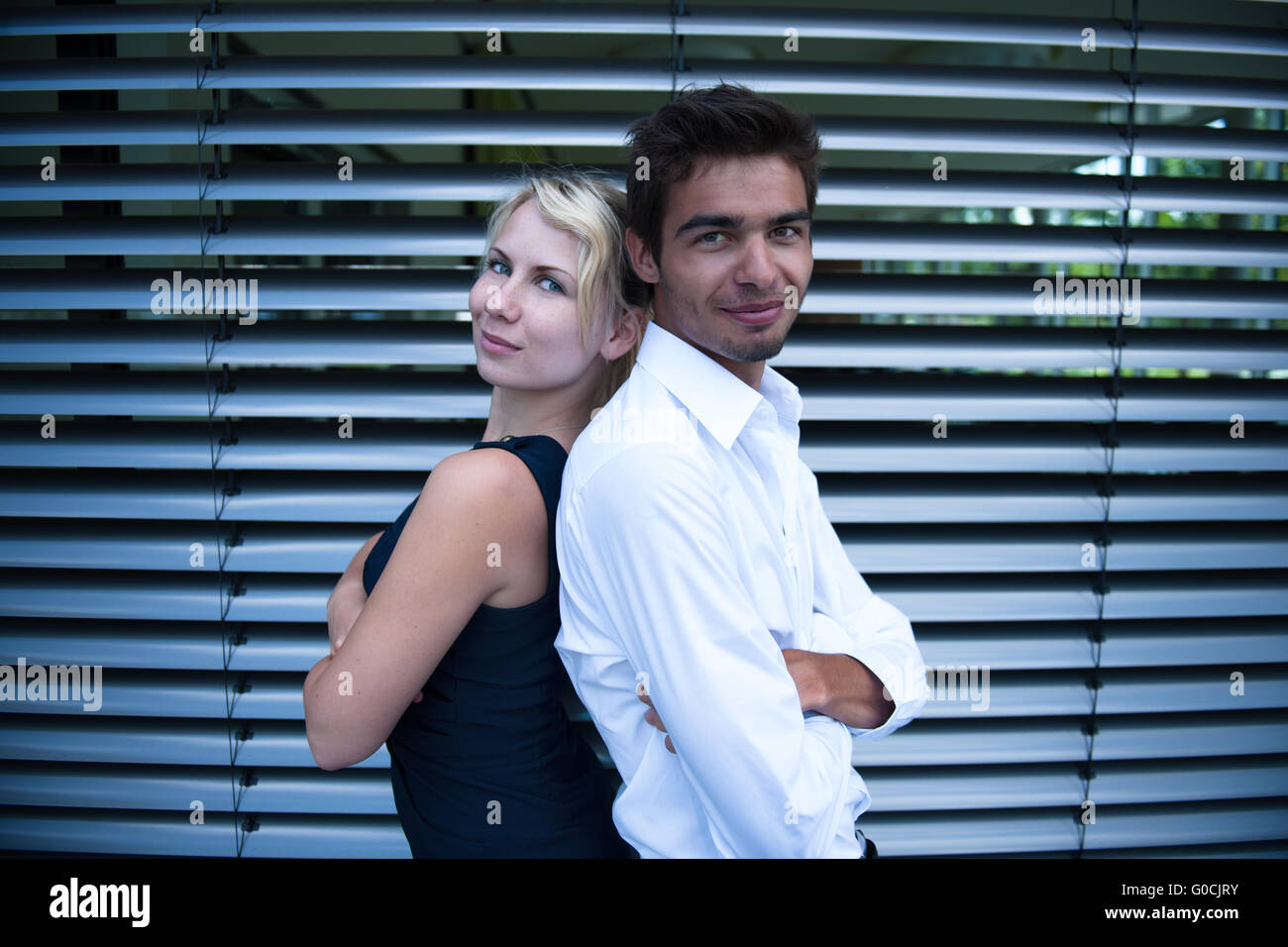 Two businessmen in front of a building back to back Stock Photo - Alamy
