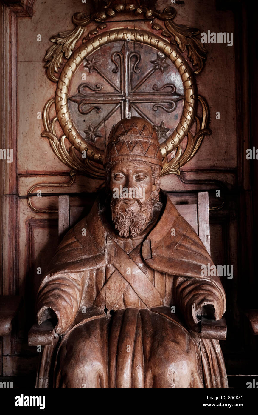 An old wooden carved figure depicting a Christian cleric at the ...