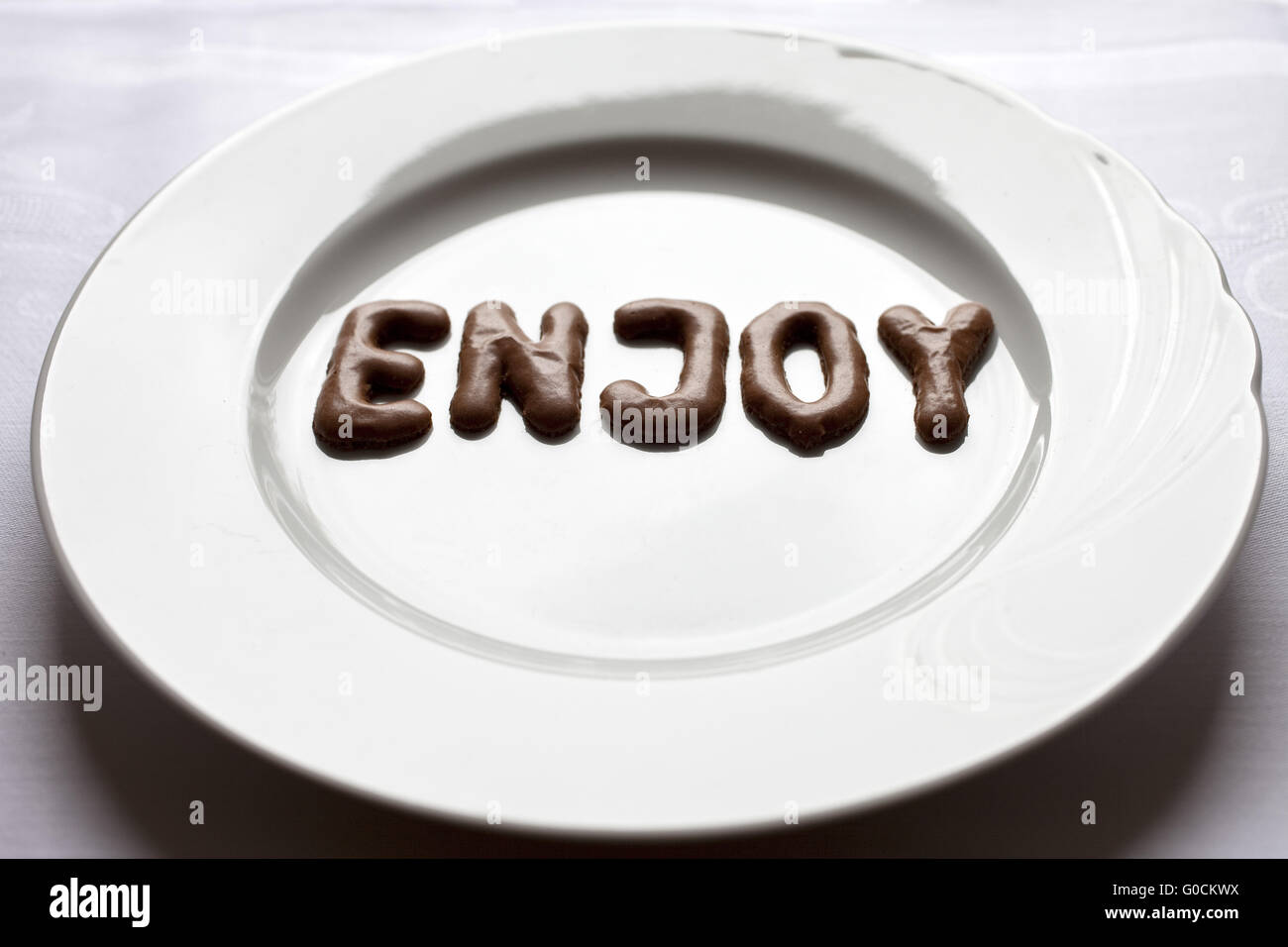 Letters forming the word enjoy on a plate Stock Photo - Alamy