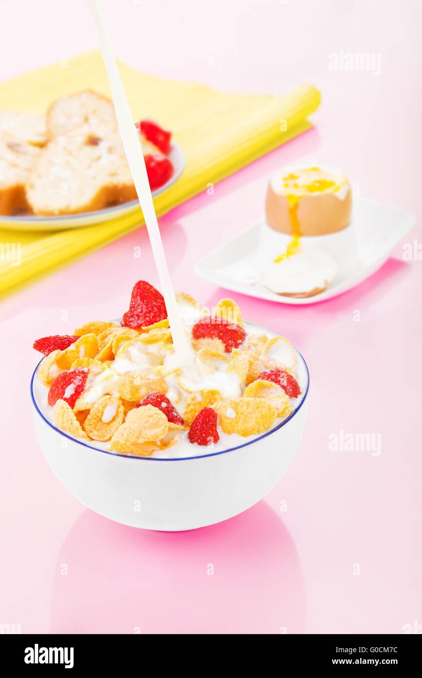 Delicious breakfast in pink and yellow. Cereal, egg and pastry Stock ...