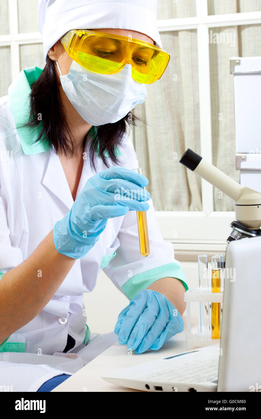 scientist in laboratory analyzing yellow liquid in Stock Photo - Alamy