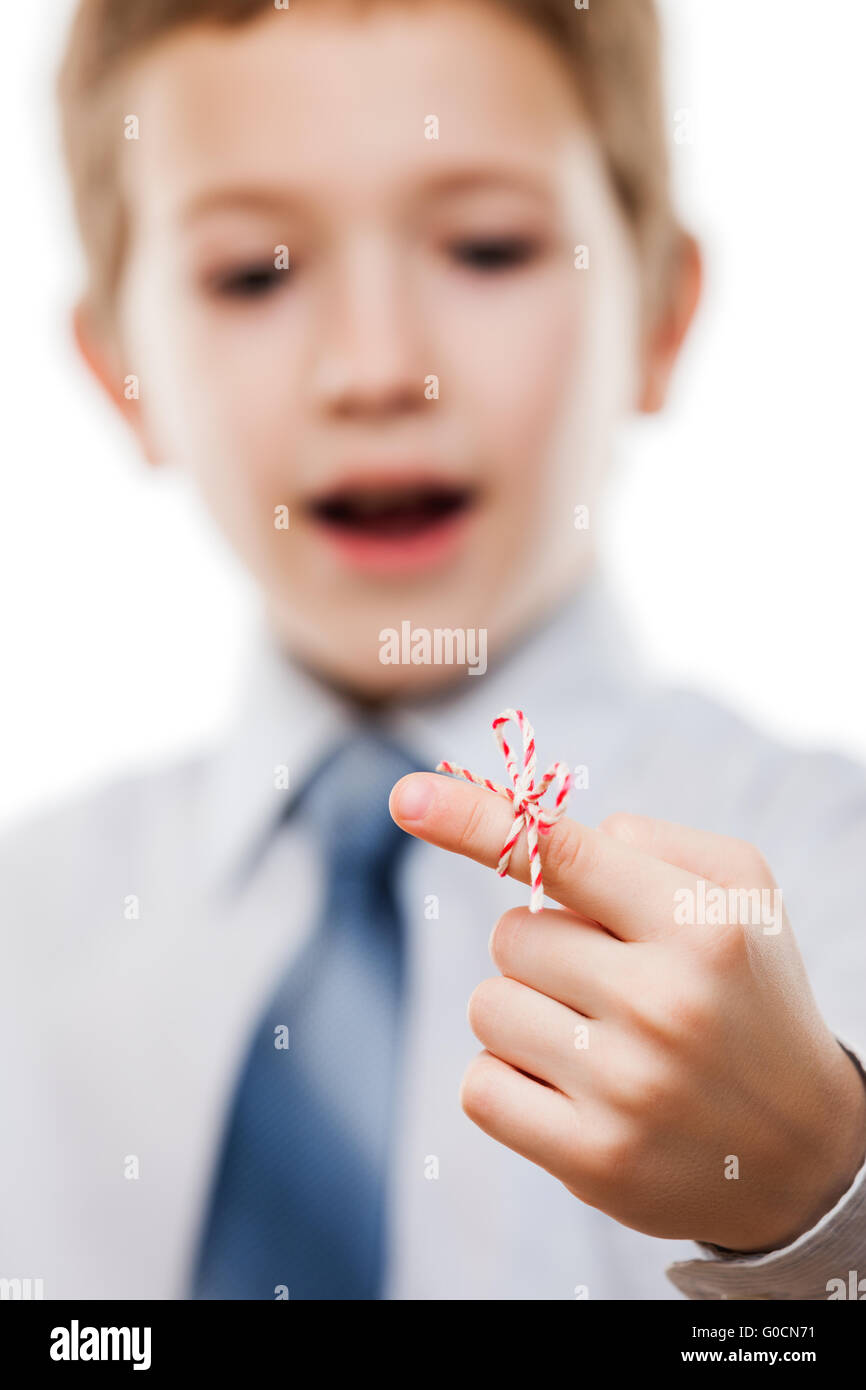Child boy look at finger tied string knot reminder Stock Photo - Alamy