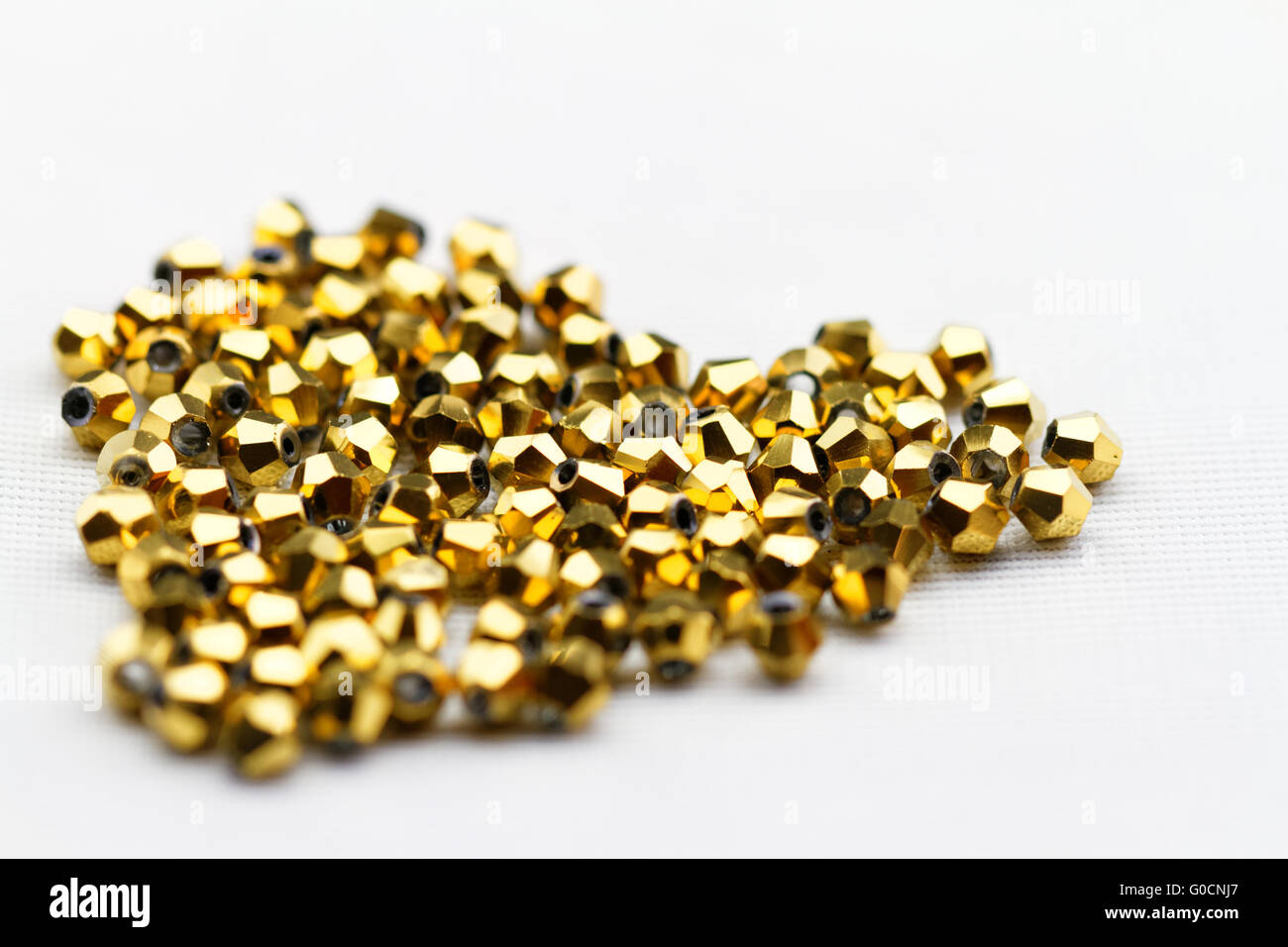 Beautiful golden glass beads closeup on white background Stock Photo ...