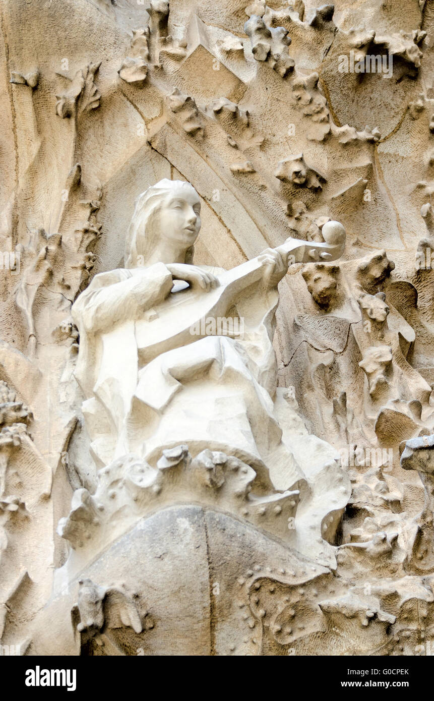 Sculpture of a woman playing on musical instrument Stock Photo - Alamy