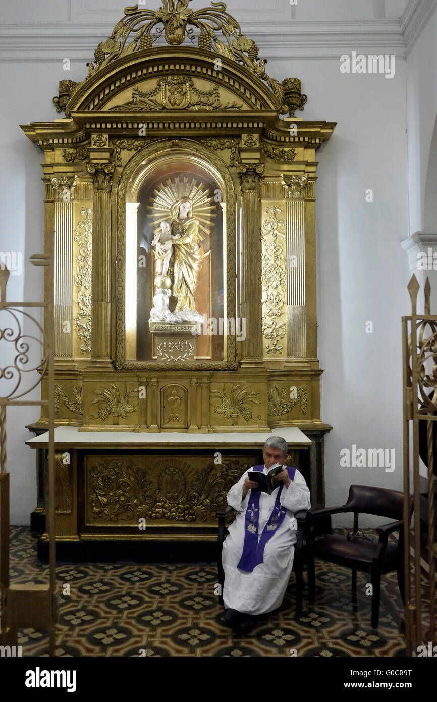 A Catholic priest inside the Metropolitan Cathedral of Guatemala City ...