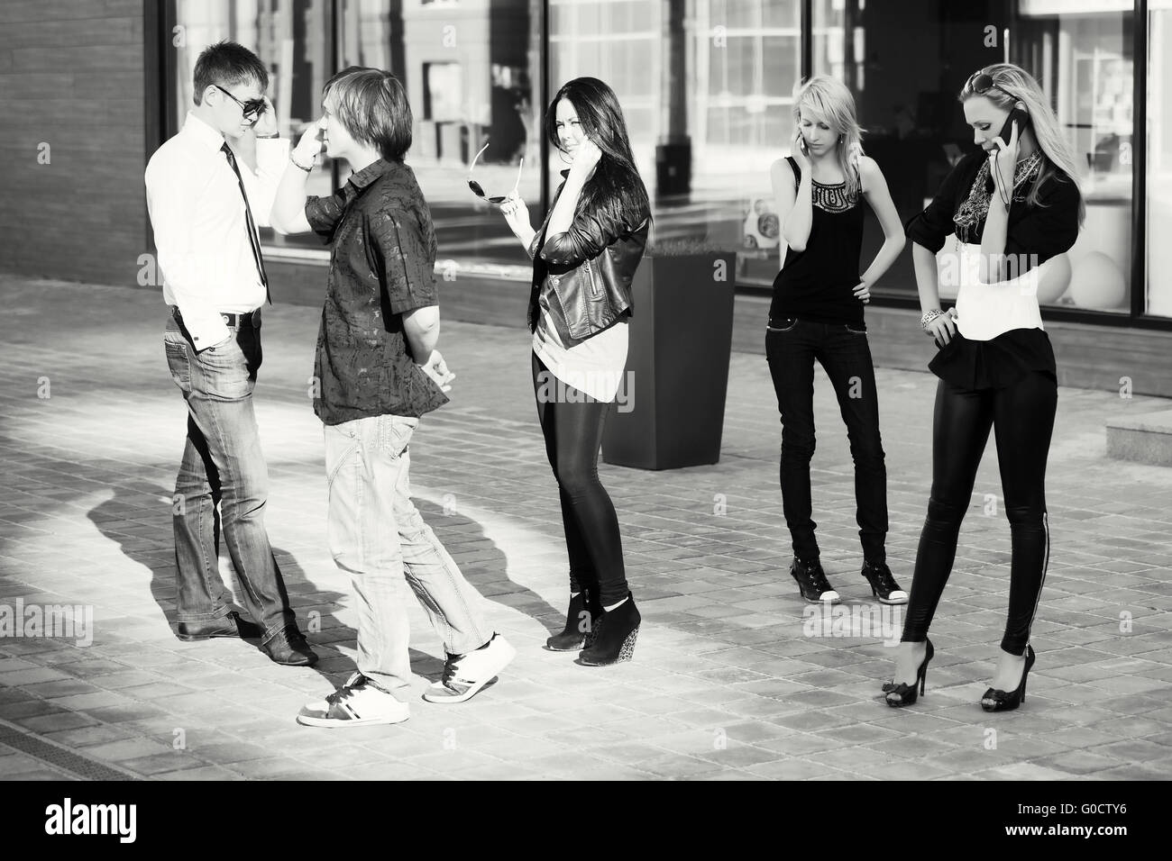 Group of young people calling on the cell phones Stock Photo - Alamy