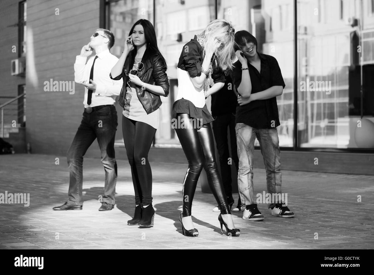 Group of young people calling on the cell phones Stock Photo - Alamy