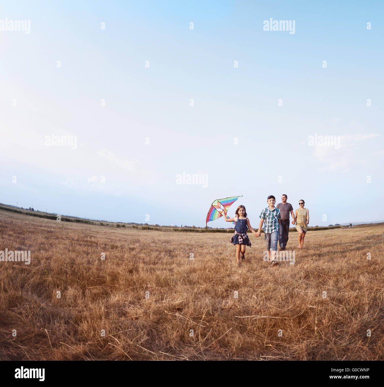 Family playing with kite Stock Photo - Alamy
