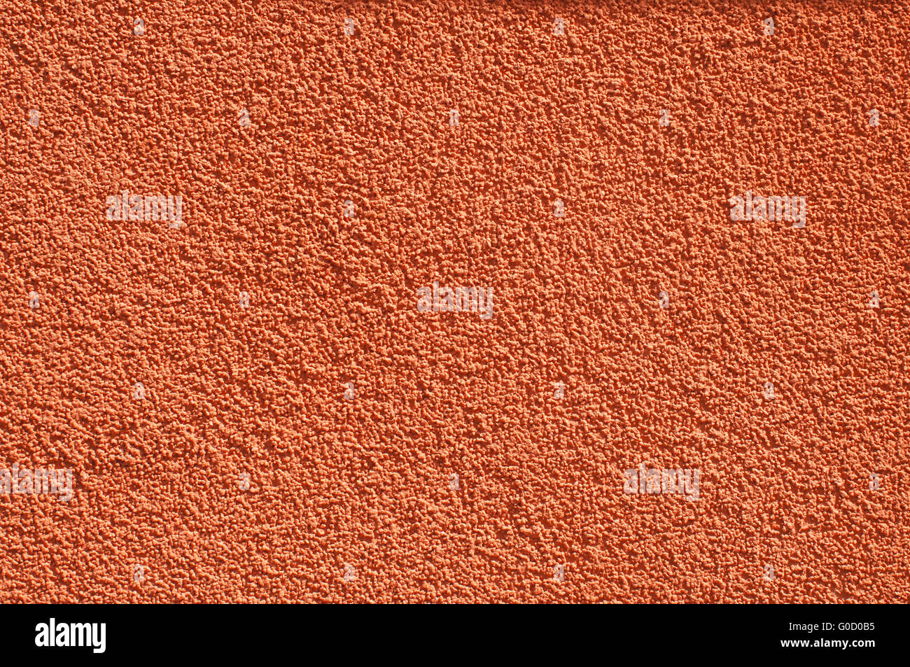 Red colored new plaster house wall facade closeup Stock Photo - Alamy