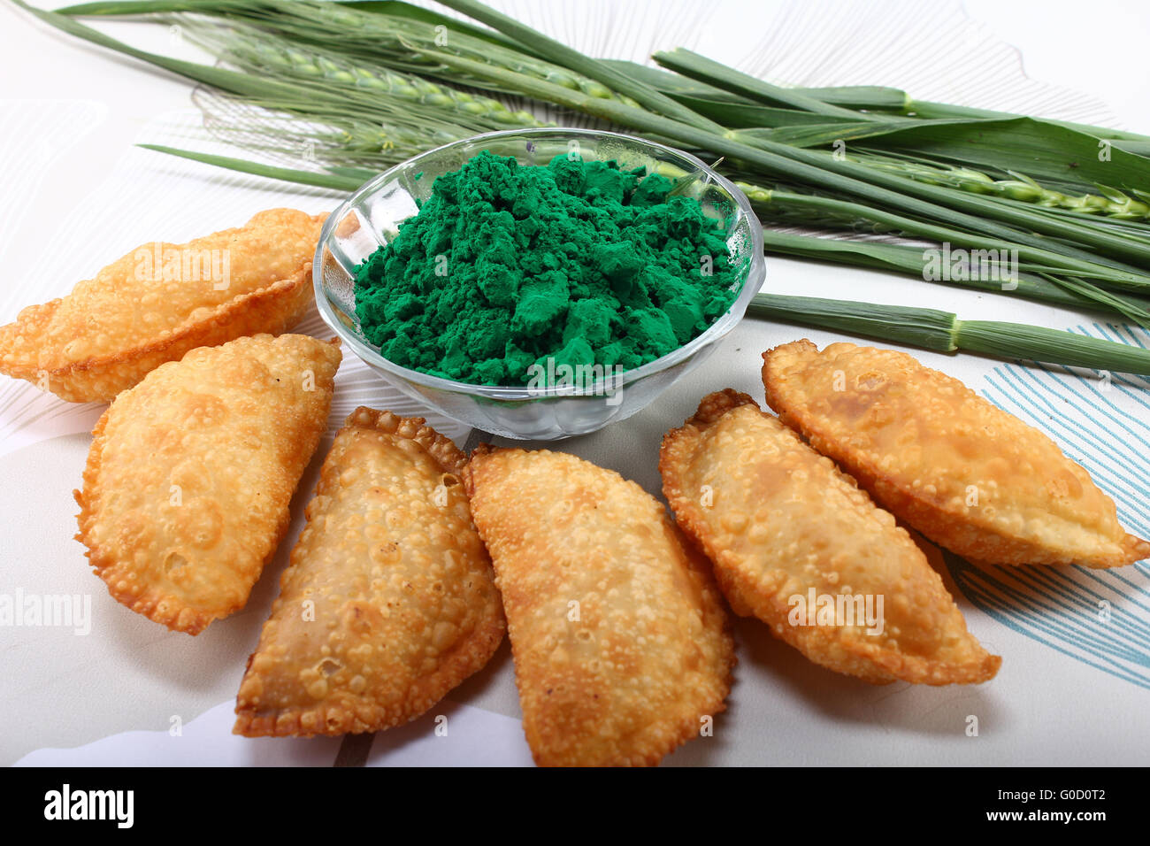 gujia in plate with holi green color in bowl Stock Photo - Alamy