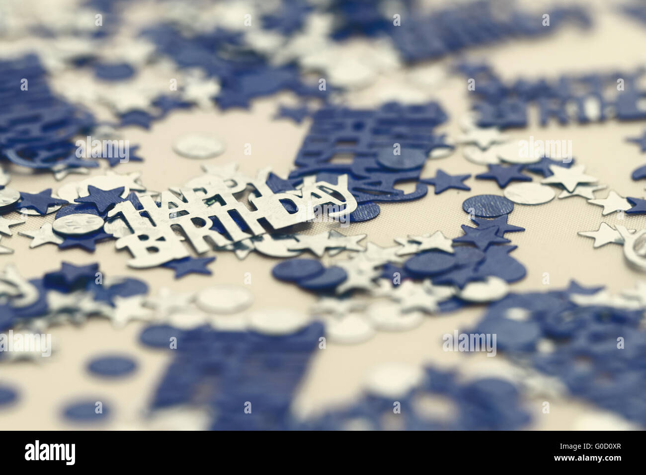 Blue happy birthday confetti pieces - macro photo Stock Photo - Alamy