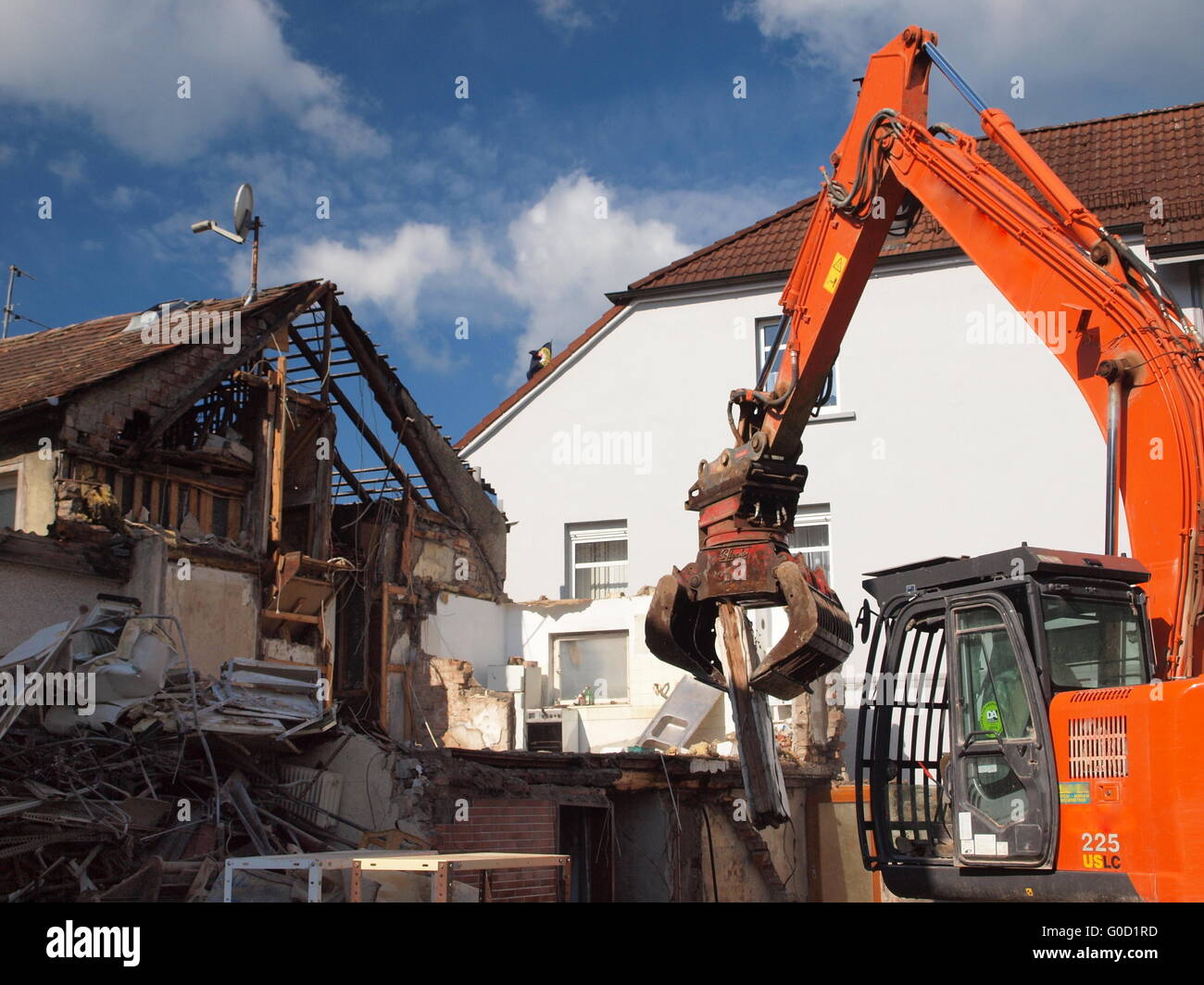 House demolition in a redevelopment area, excavato Stock Photo - Alamy