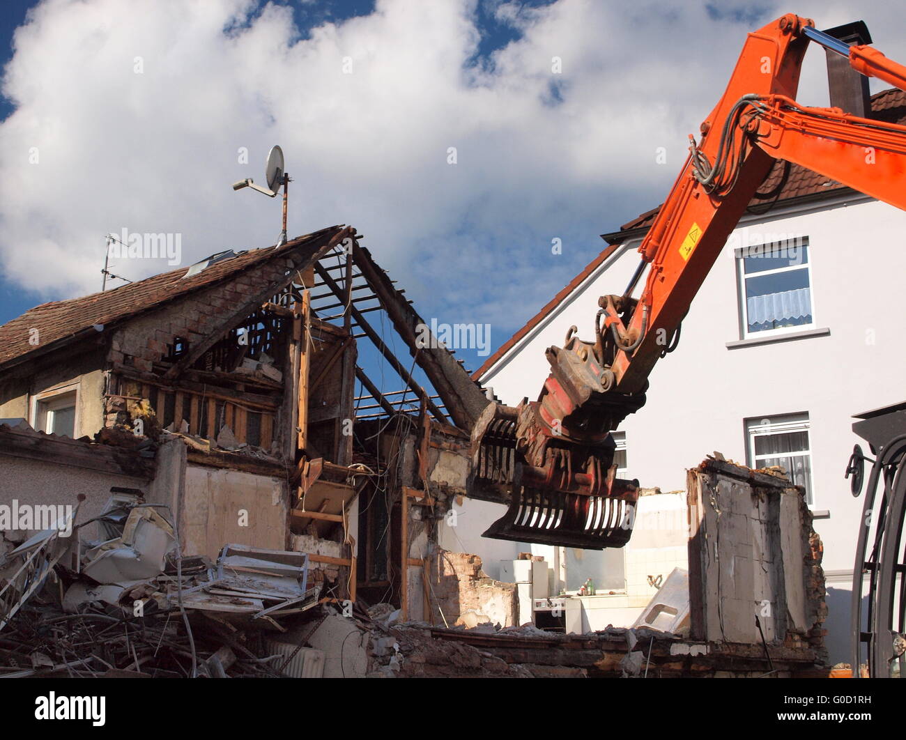 House demolition in a redevelopment area, excavato Stock Photo - Alamy