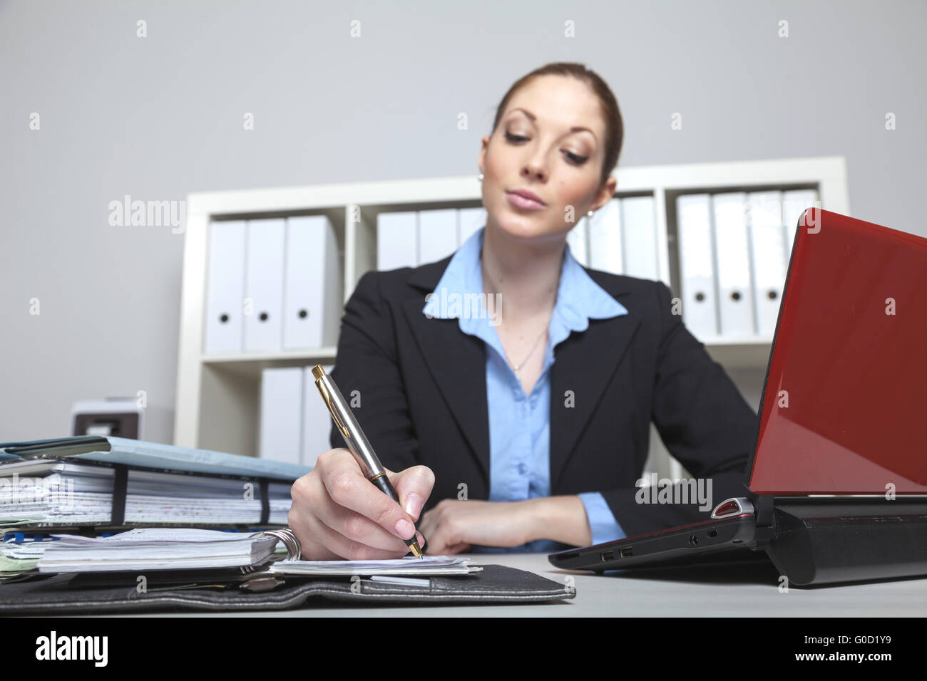 Businesswoman makes a note Stock Photo - Alamy
